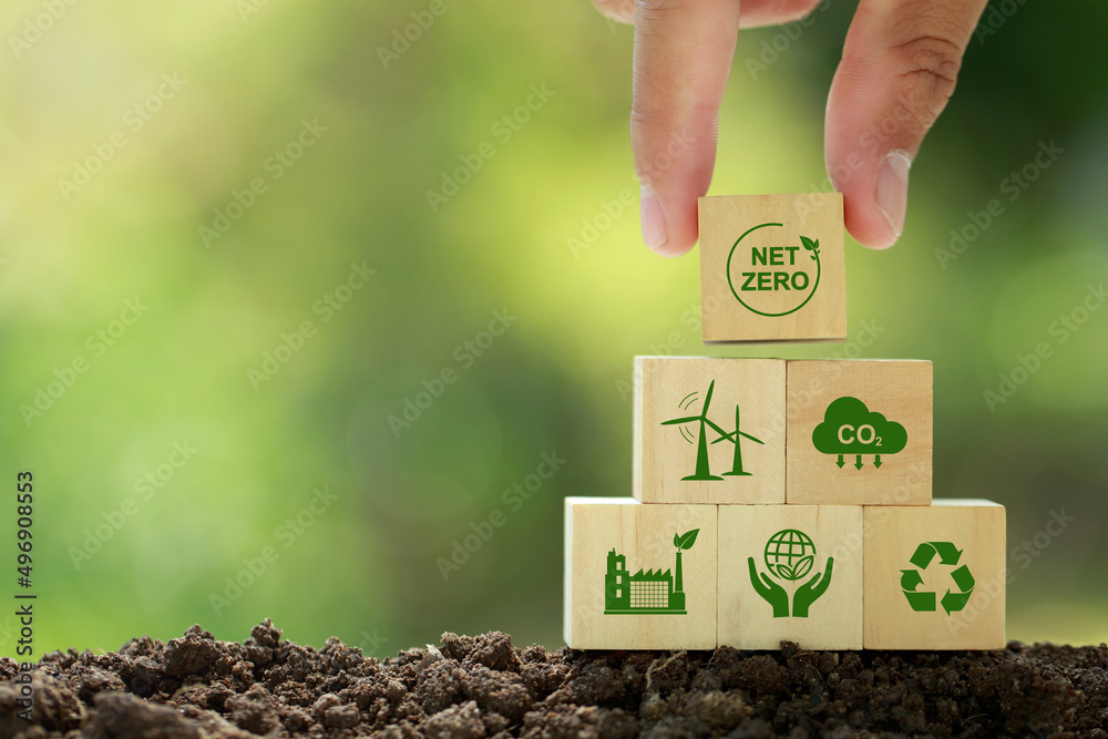 Net zero and carbon neutral concept. Hand puts wooden cubes with ...
