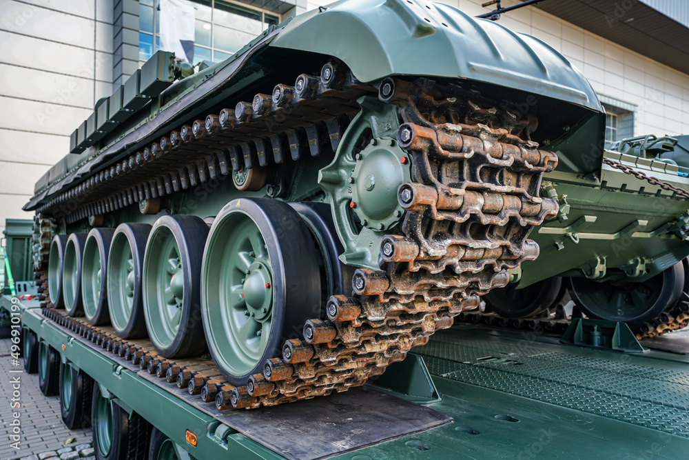 Tank armoured vehicle loaded on truck, detail to continuous tread ...