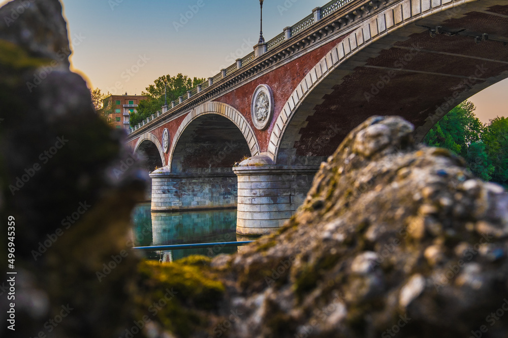 Beautiful sunset view of the arch bridge over the river Po in the city ...