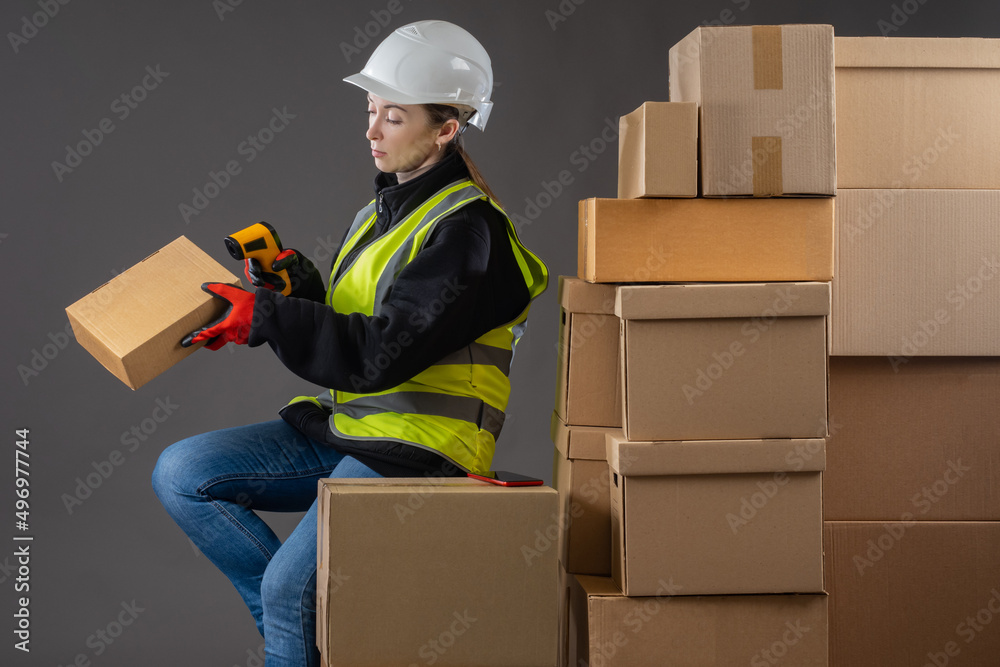 Warehouse woman. Woman with data collection terminal. Girl scans ...