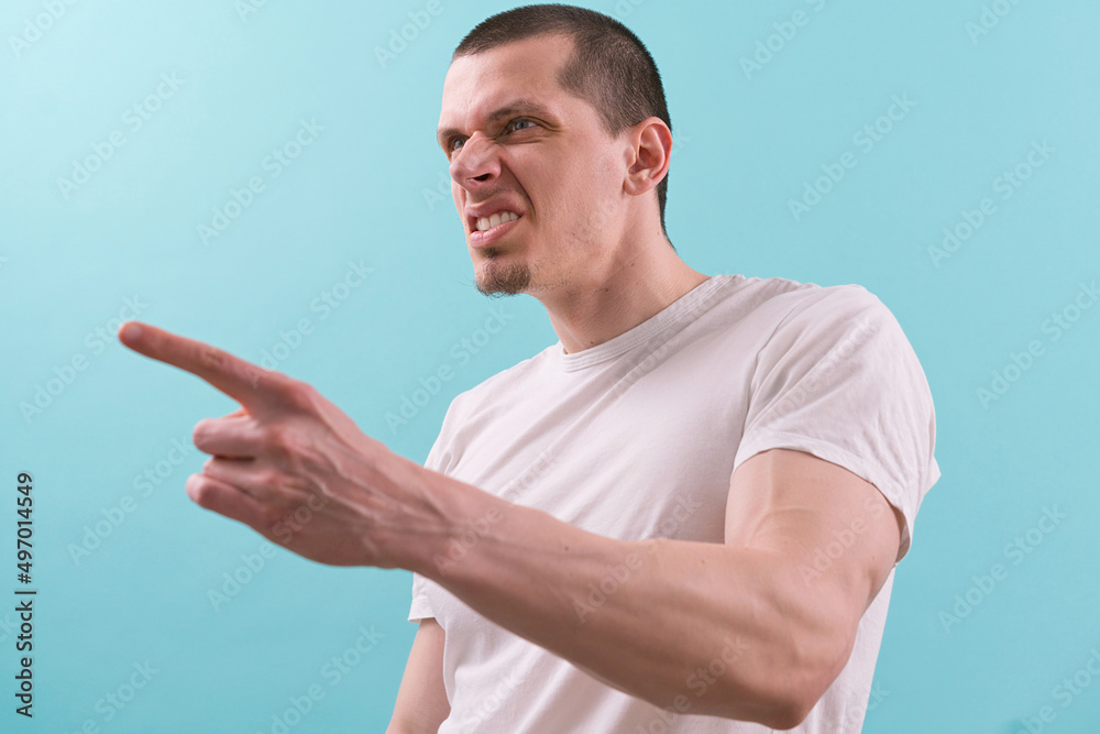 Side view of an angry man screaming and pointing a finger at something ...