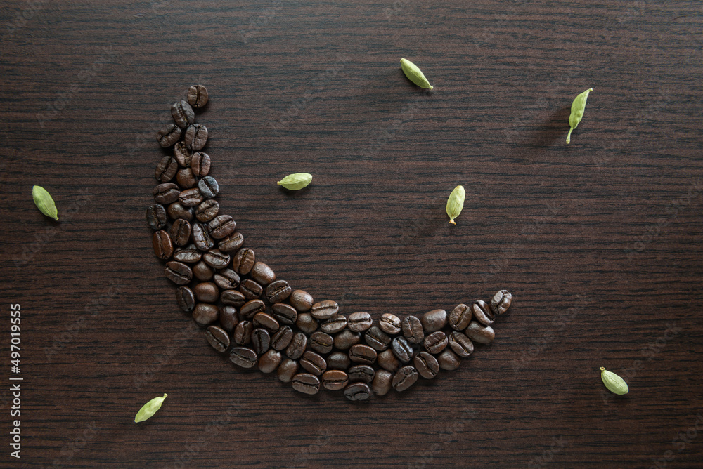 Roasted coffee beans arranged in a shape of moon, surrounded by green ...