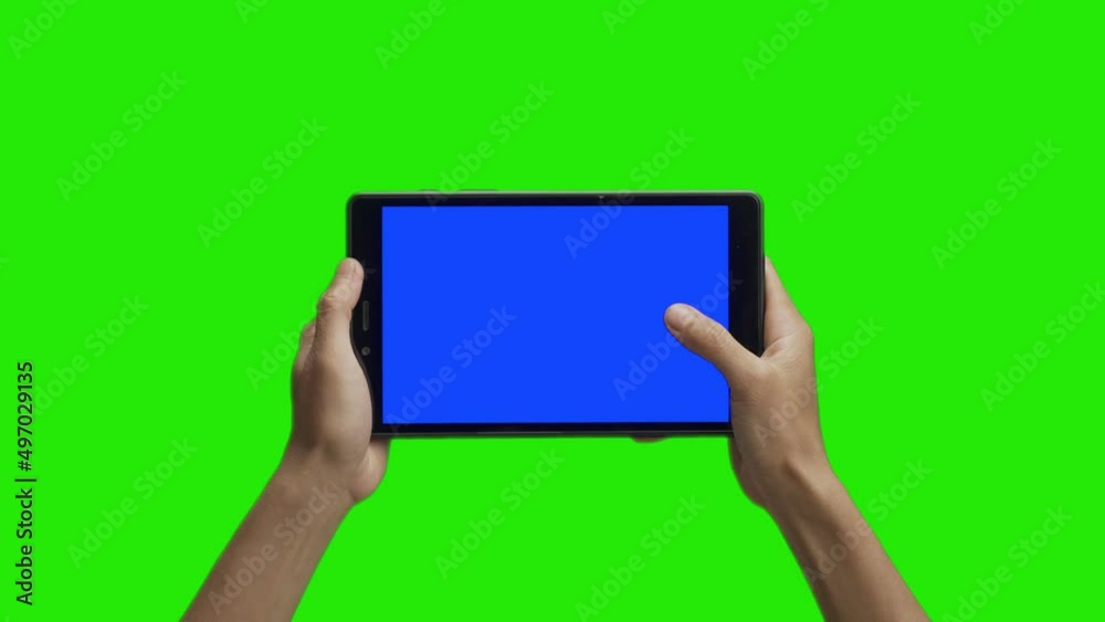 Vidéo Stock Tablet in the hand close up isolated at green background ...