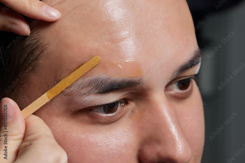 Professional barber doing threading procedure and correcting shape of ...