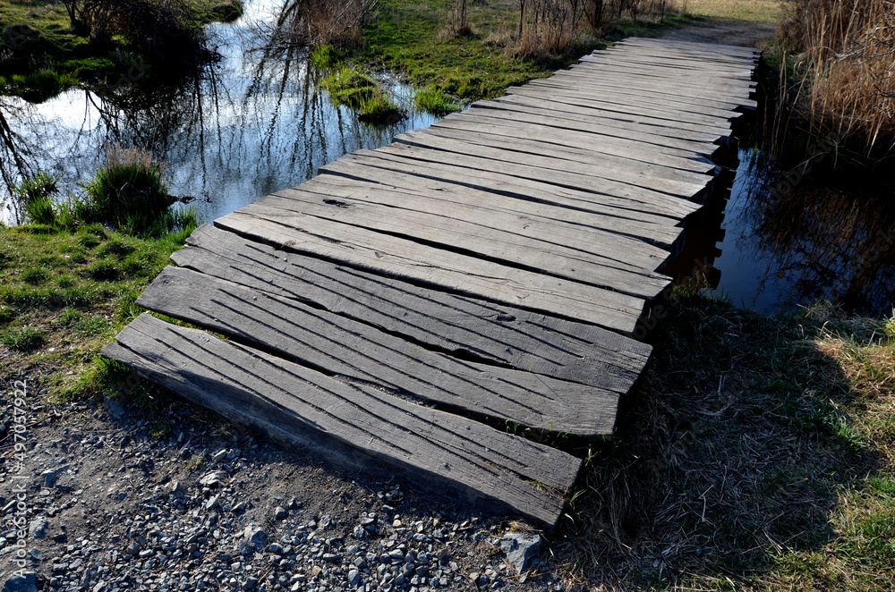 floating walkway made of wooden planks, pier, narrow curved paths on ...