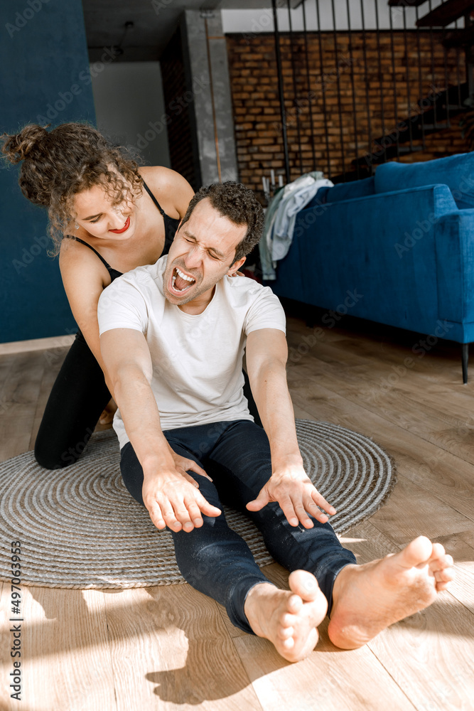 Fit young man doing sport exercise at home with laptop lying on floor ...