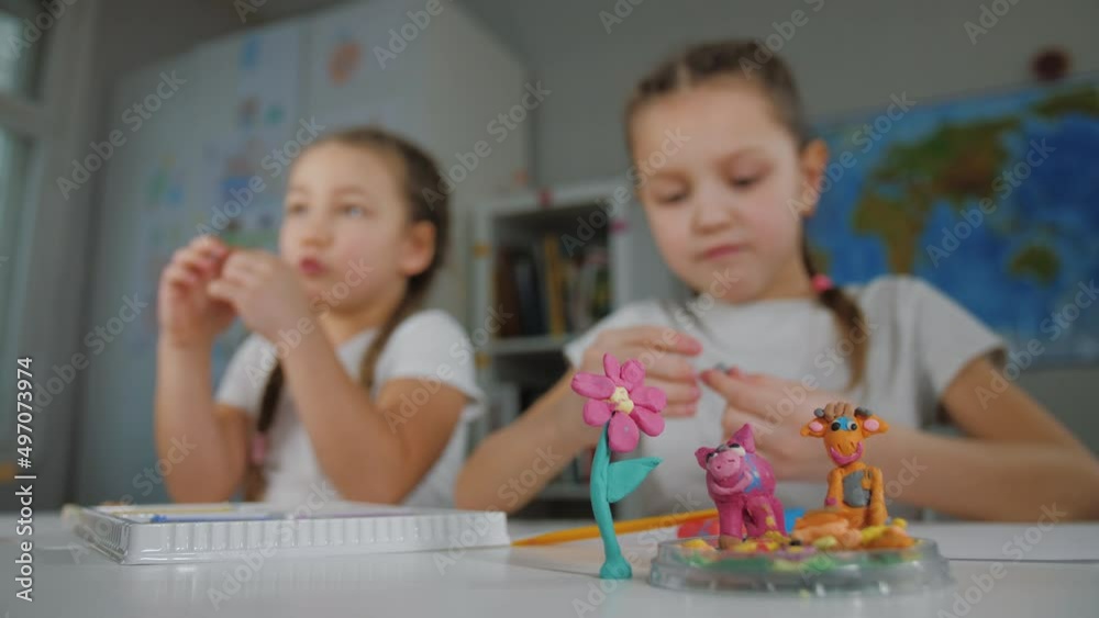Two cute preschool girls making toys sculpting playdough, sculpt ...