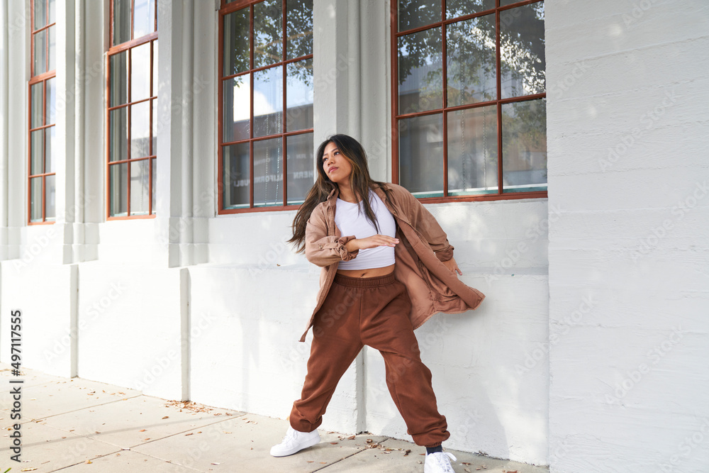 woman dancing by white wall with windows Stock Photo | Adobe Stock