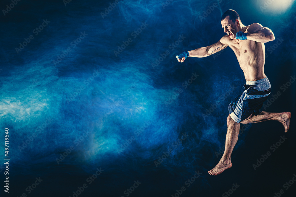 The professional athlete boxer in jump isolated on dsrk studio ...