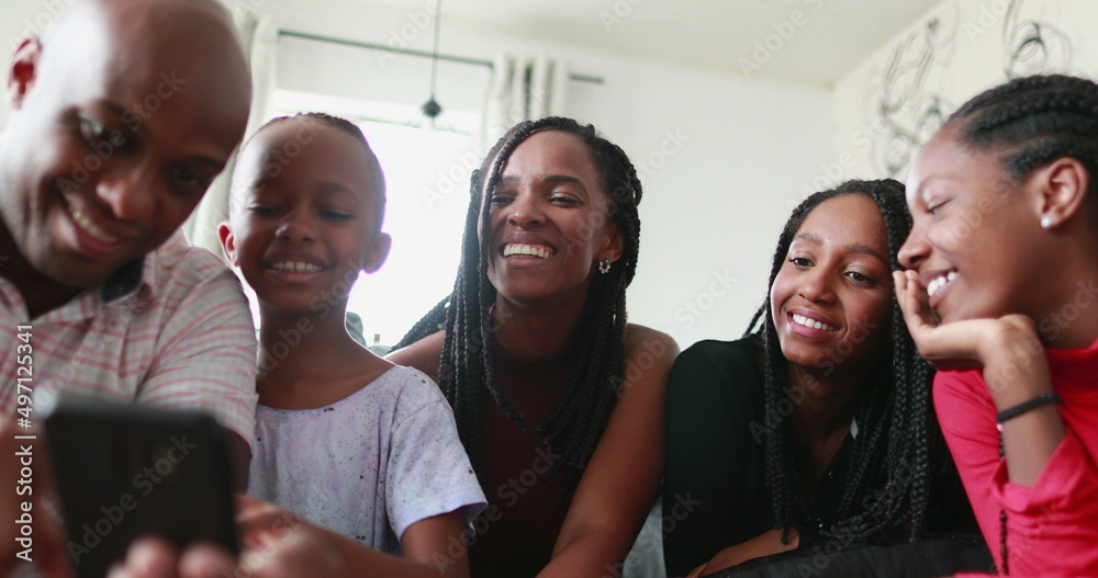 Father showing cellphone screen to children, family gathered togehet ...