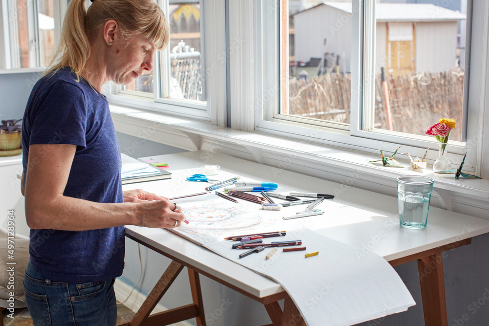 Mature woman drawing at home Stock Photo | Adobe Stock