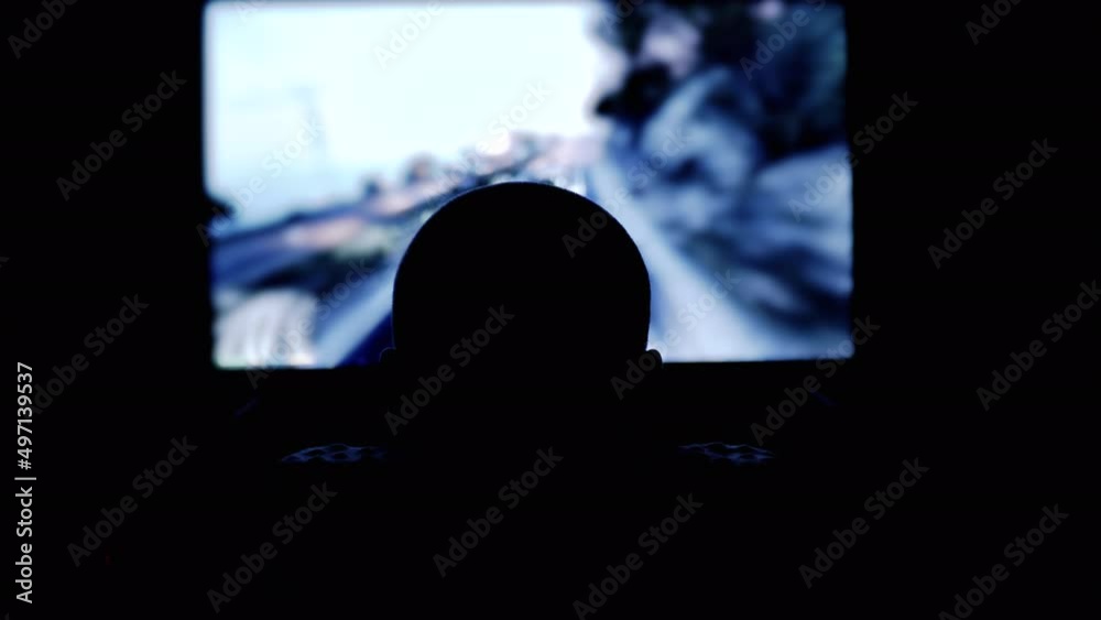 Silhouette of Head an Anonymous Person Looking at the TV Screen. Back ...