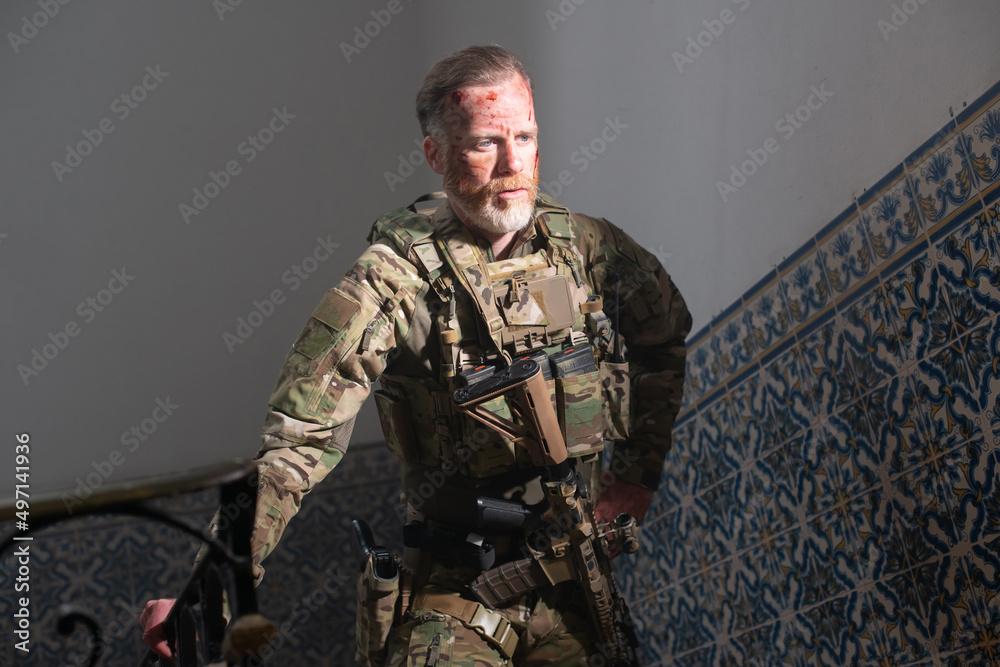 Tired army man resting after battle. Caucasian man with beard with ...