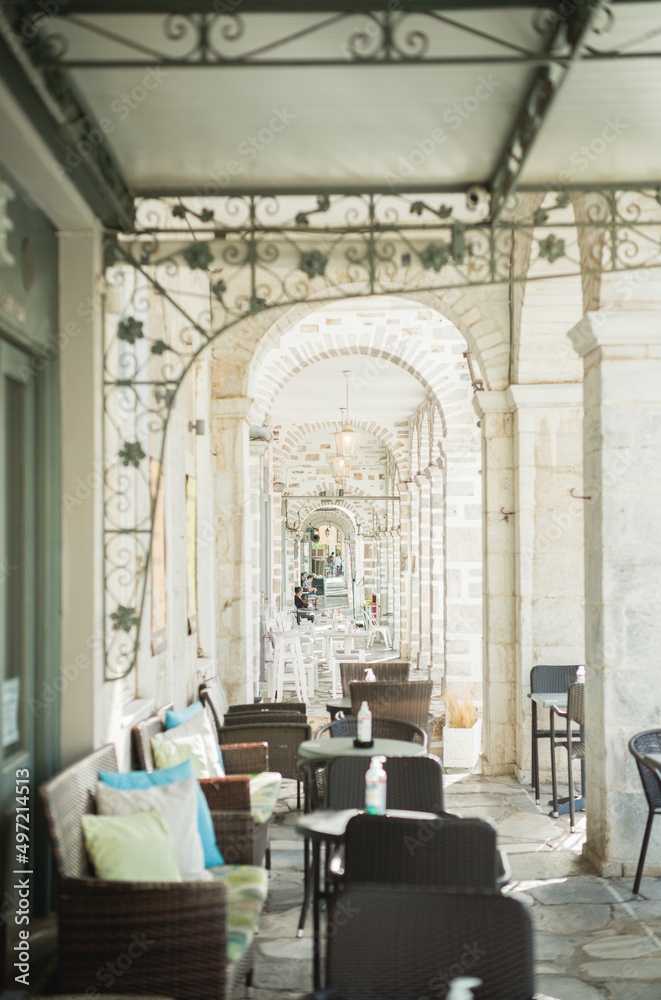 Greek terrace or tavern in the center among the columned buildings with ...