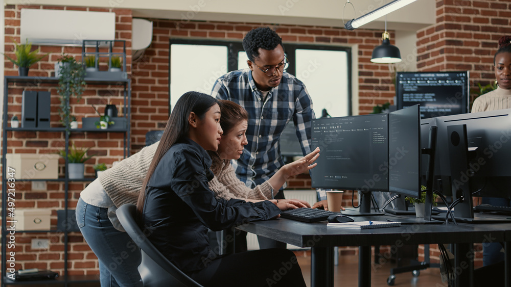 Mixed team of software engineers brainstorming ideas for new cloud computing user interface ...