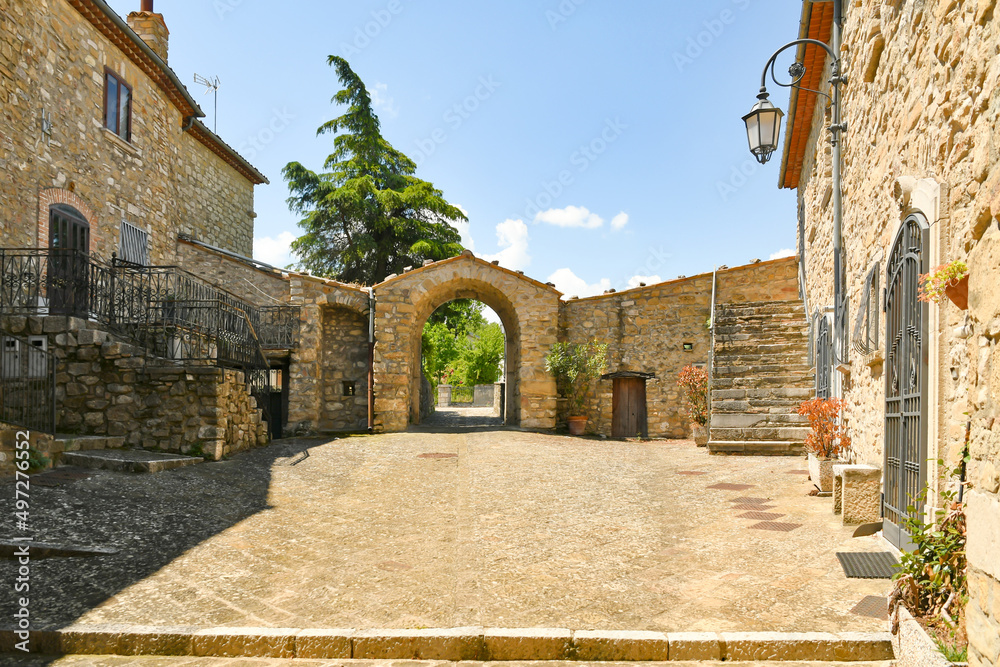 Narrow street among the old houses of Ruvo del Monte in a medieval ...