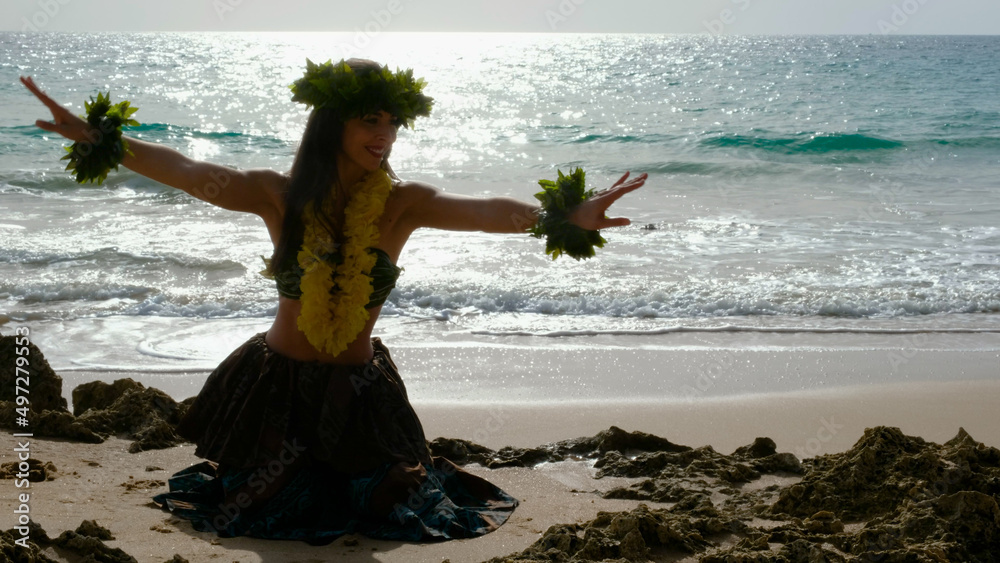 Happy and calm woman poses on the beach wearing the typical hula dance ...