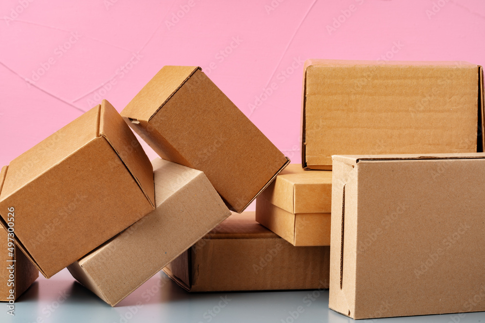 Set of cardboard boxes on pink background Stock Photo | Adobe Stock