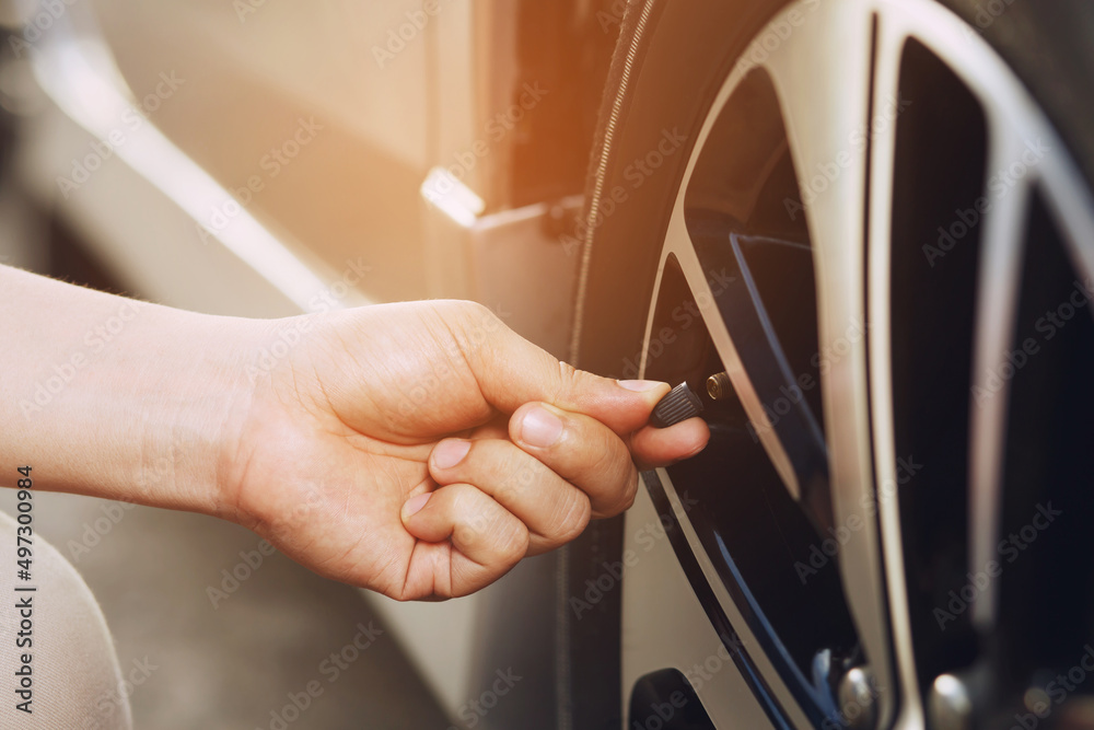 close up hand man car parking a check and inflate the tire fill up the ...