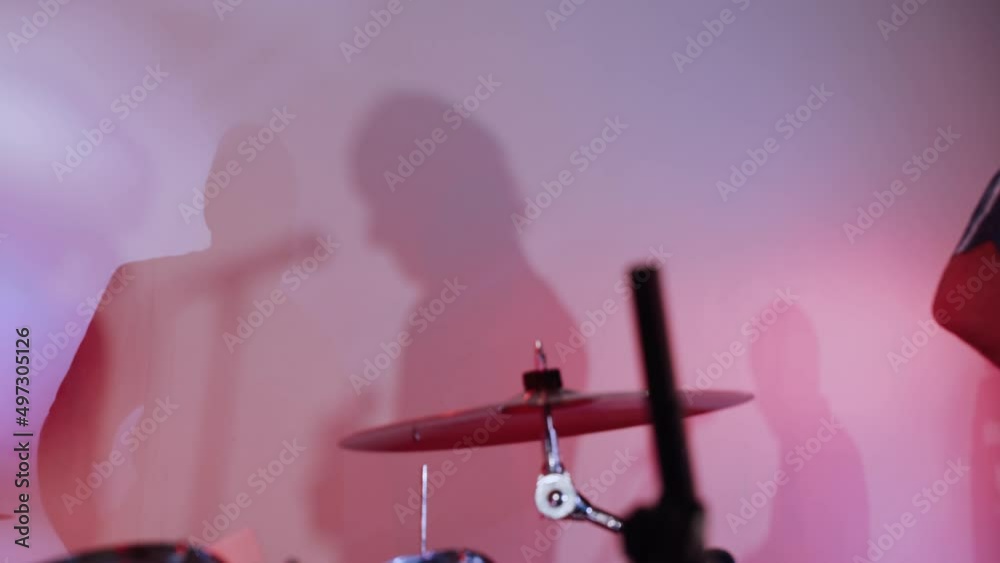 Beating drumsticks on cymbal and rhythm on drum. Multi-colored shadow ...