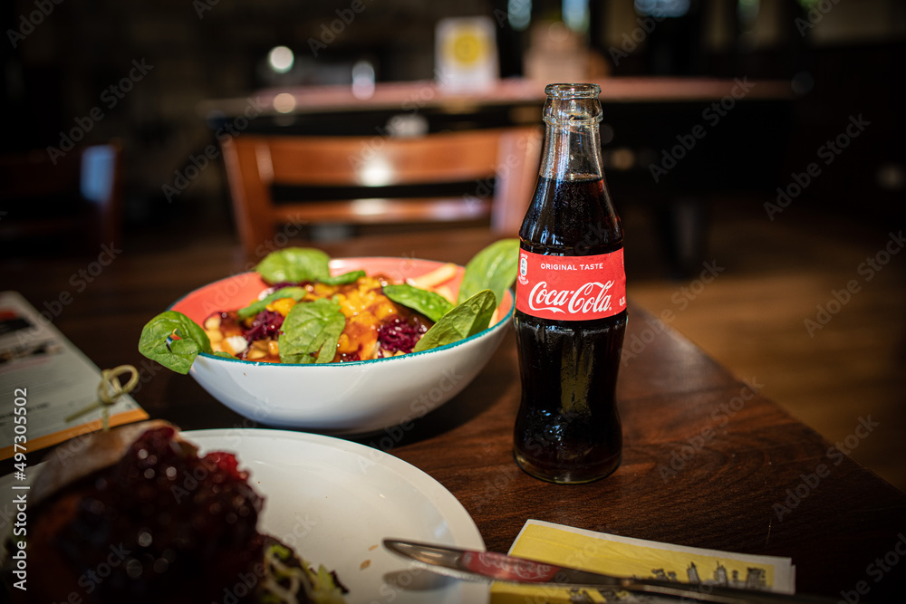 Coca Cola bottle in a typical American restaurant with burgers and ...