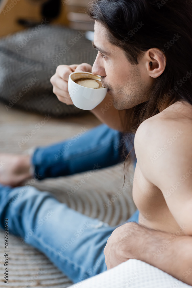 shirtless man with long hair drinking coffee from cup at home. Stock ...
