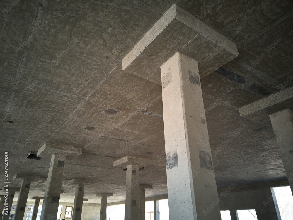 Concrete pillars with metal embedded parts and slab. Structures of ...