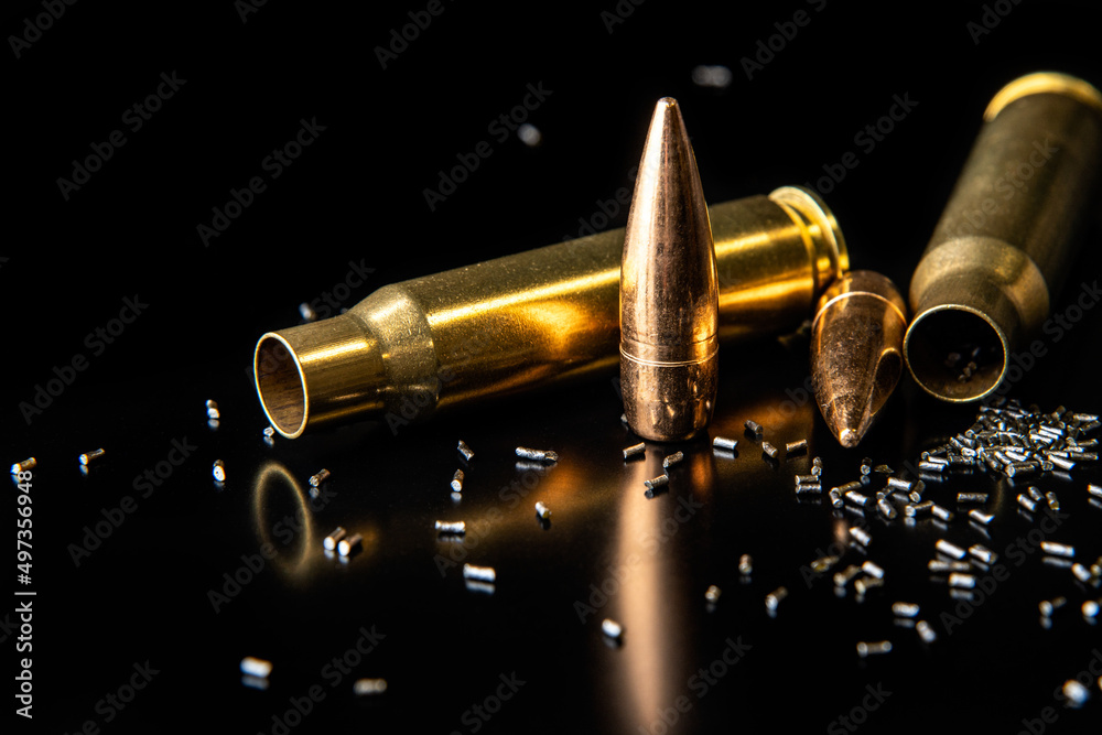Bullet isolated on black background with reflexion. Rifle bullets close ...