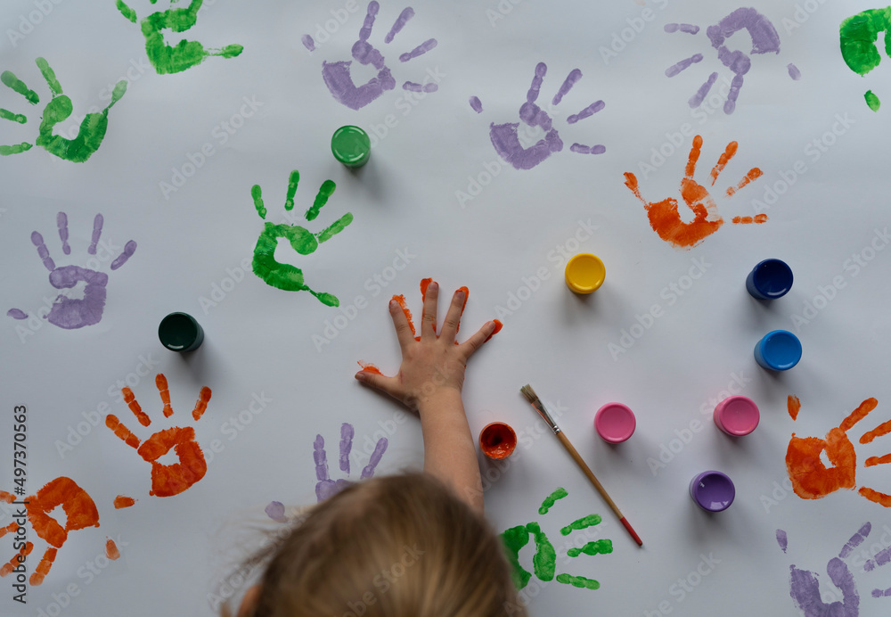 child painted hands on a white backgound. Colorful imprint and ...