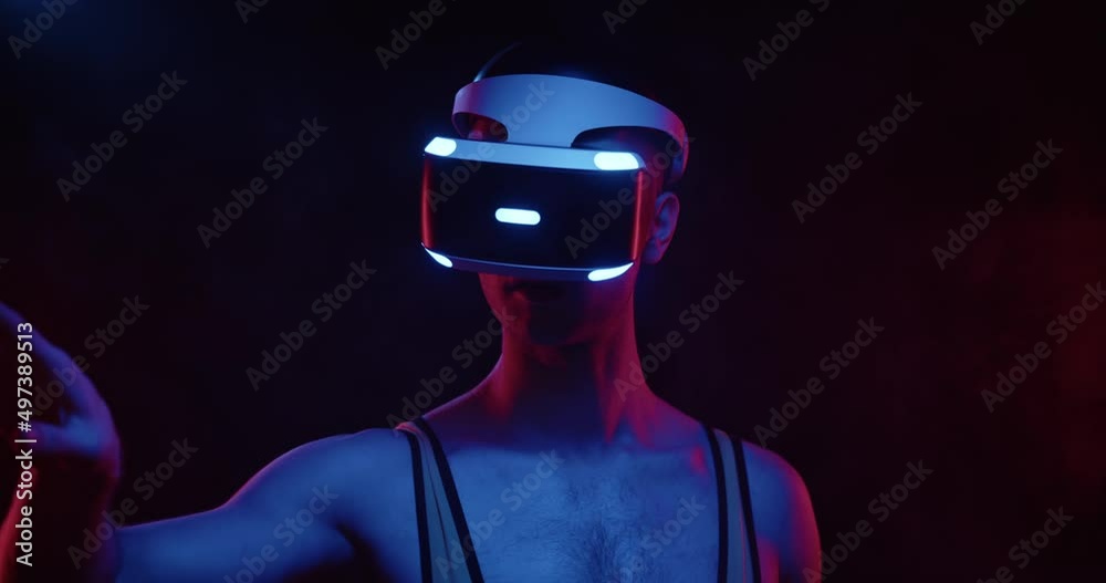 Stylish future handsome young man gamer wearing VR headset on black ...