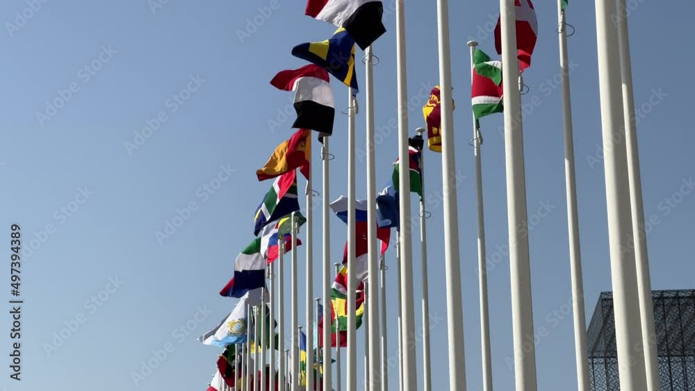 Flags of many Nations against a blue sky - national flags of various ...