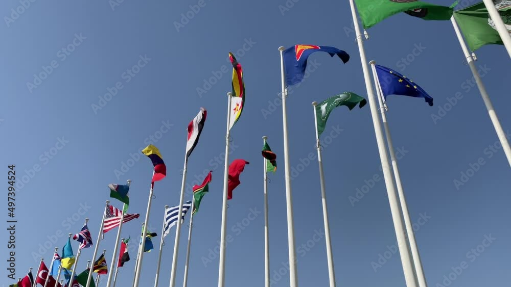 Flags of many Nations against a blue sky - national flags of various ...