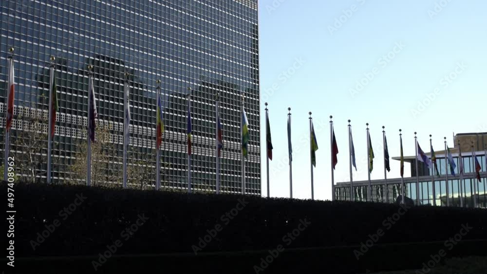 Multiple flags in front of the United Nations headquarters in New York ...