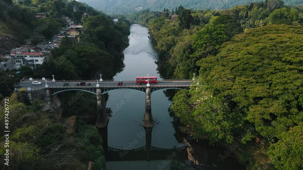 Several traditional Tuktuks ride between cars and buses over the tall ...