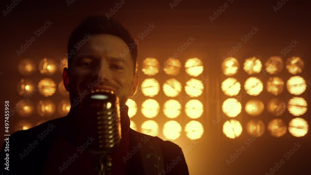 Handsome man singing mic on stage close up. Vocalist performing in ...
