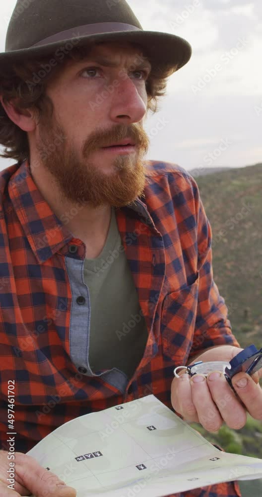 Vertical video of bearded caucasian male survivalist with map and ... Vertical video of bearded caucasian male survivalist with map and ...