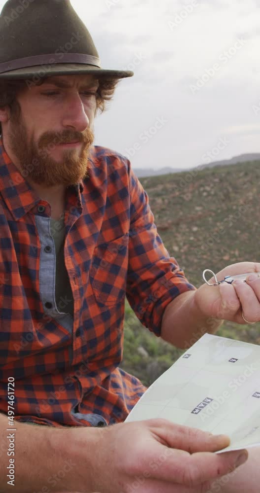 Vertical video of bearded caucasian male survivalist with map and ... Vertical video of bearded caucasian male survivalist with map and ...
