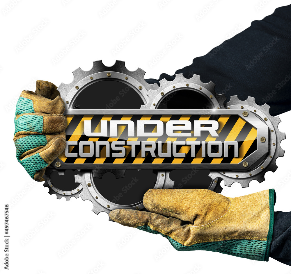 Gloved hand holding an under construction sign with metal cogwheels ...