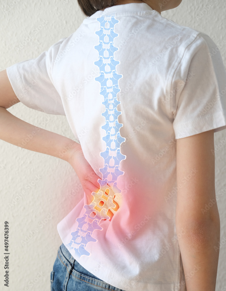 back of boy, child 8-10 years old in a white t-shirt grabbed a sore ...