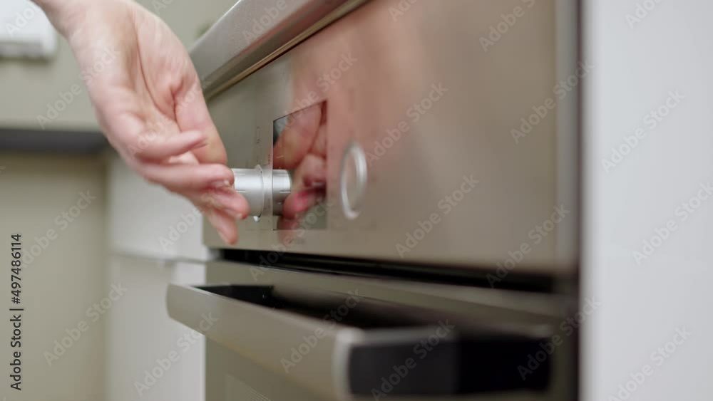 cook or housewife turn off oven and stop cooking process. process of ...