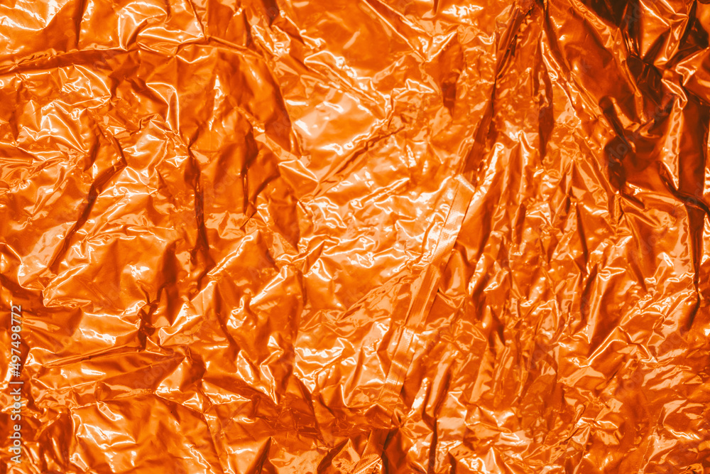 Full frame creased shiny metal foil sheet in trich golden red color ...