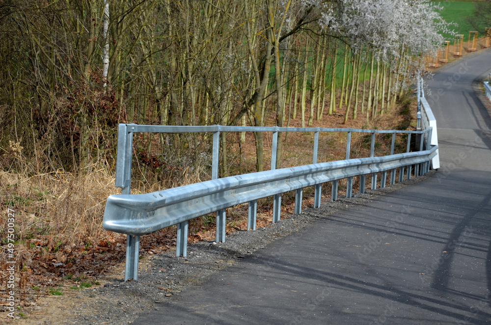 path for cyclists with an asphalt surface. galvanized iron railing over ...