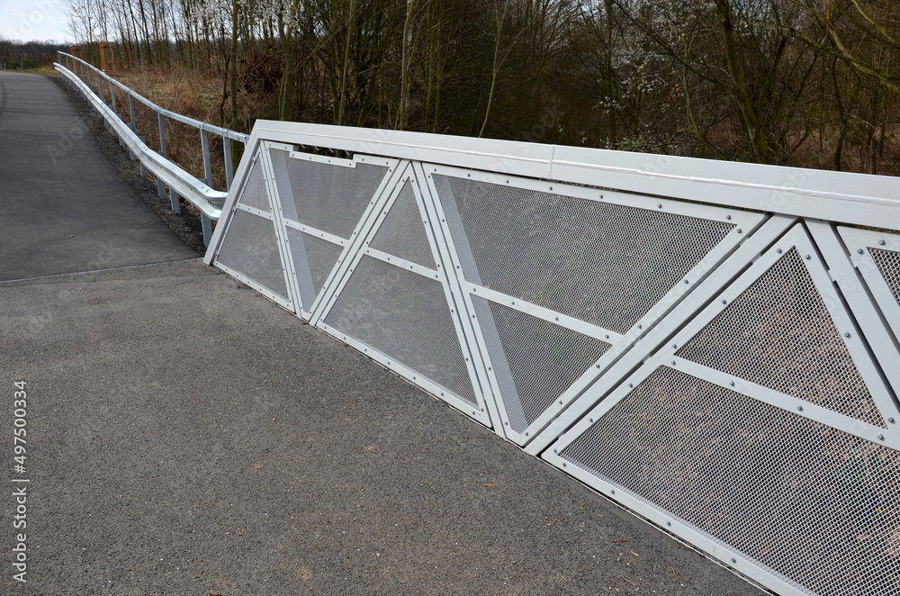 path for cyclists with an asphalt surface. galvanized iron railing over ...