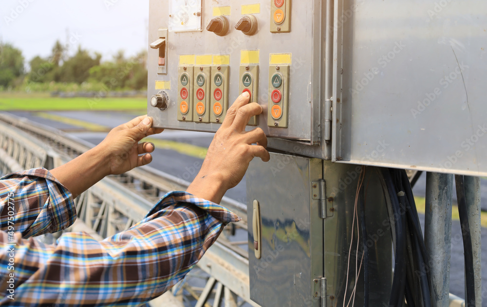 Man's hand's farmer pressing keys to operate agricultural machinery ...