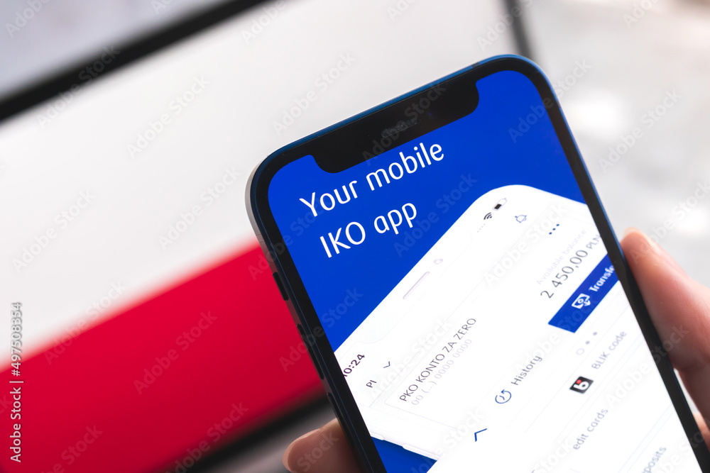 IKO mobile banking app in Poland. Hand with smartphone, logo on the ...