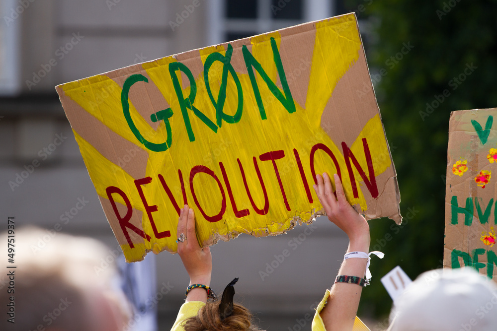 Hands holding a sign during a protest for climate change, global ...