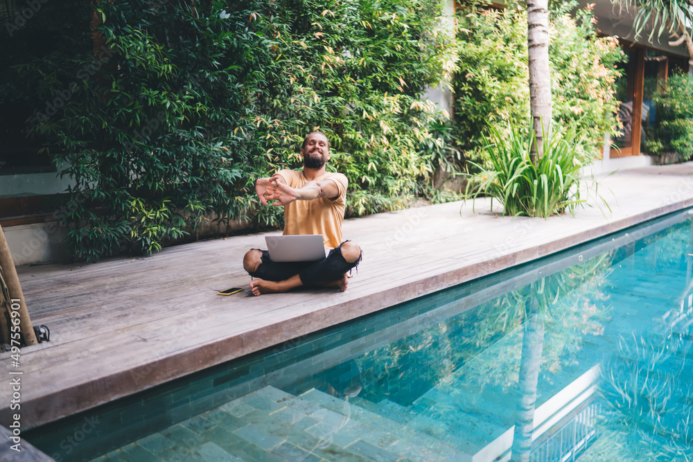 Portrait of Caucasian IT professional stretching hands while doing ...