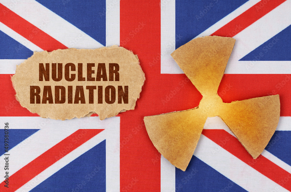 On the flag of Great Britain, the symbol of radioactivity and torn ...