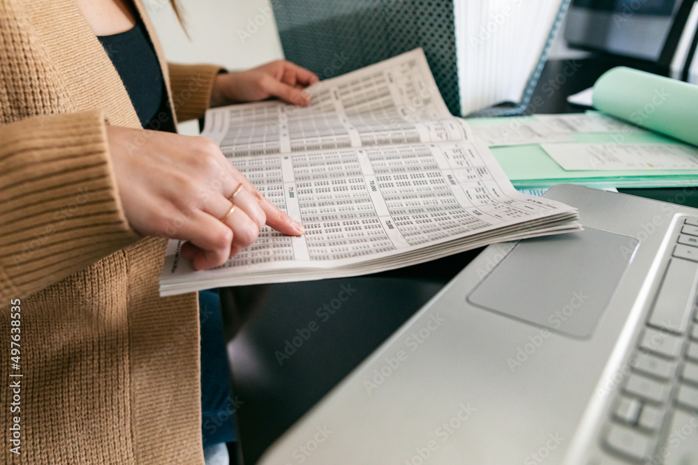Taxes: Woman Looking At Income Tax Charts Stock Photo | Adobe Stock