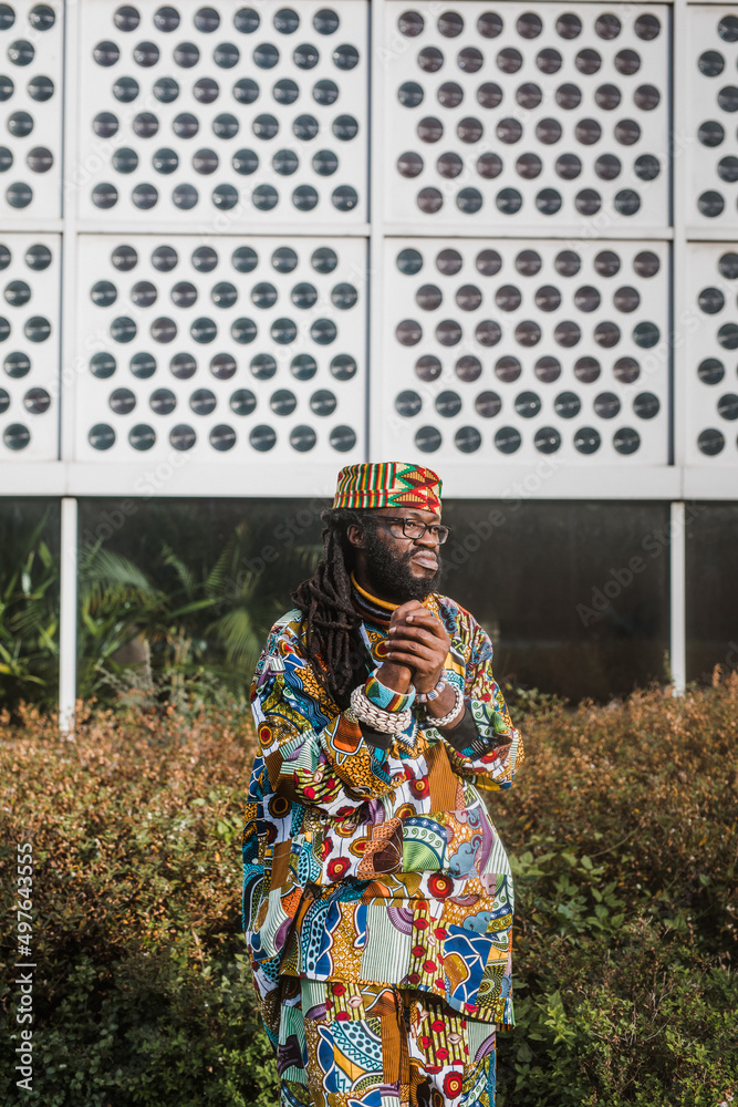 Man in colourful African outfit hands in a prayer Stock Photo | Adobe Stock